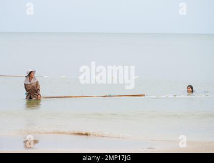22 January 2023- Chumphon Thailand fishermen fish with nets in shallow ...