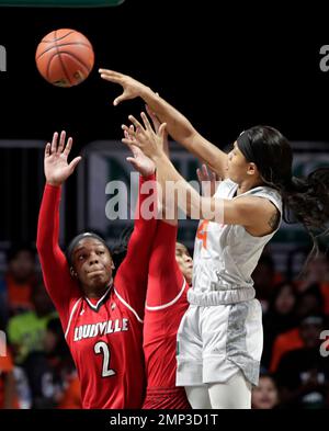 Miami's Shaneese Bailey passes as Louisville's Jazmine Jones (23) and ...
