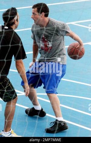 Actor Adam Sandler enjoys some downtime by playing basketball on the ...