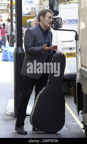 '70s pop icon Alvin Stardust (Shane Fenton) carries his guitar as he ...