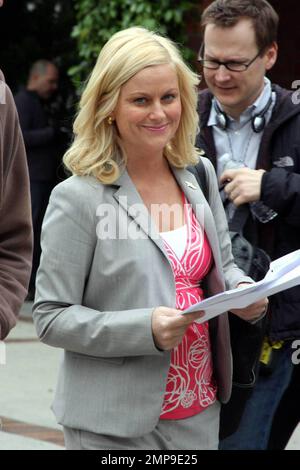Comedienne and actress Amy Poehler goes over a script as she strolls on ...