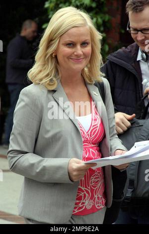 Comedienne and actress Amy Poehler goes over a script as she strolls on ...