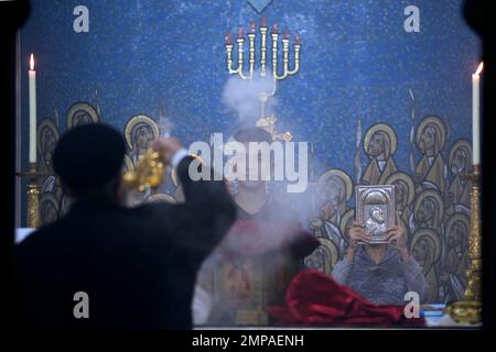 A priest spreads incense during in activities to commemorate Palm ...