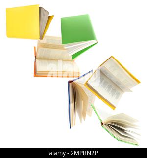 Colorful hardcover books flying on white background Stock Photo - Alamy