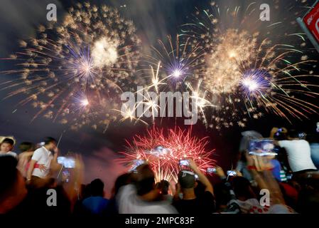 Filipino revelers watch as fireworks light up the sky to welcome the ...