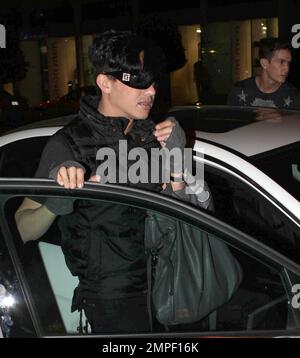 Fashion Designer Bobby Trendy strikes his usual poses in high heels as ...