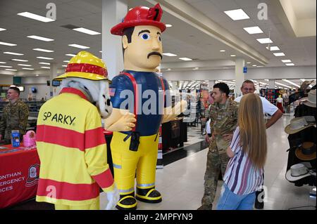 Fire mascots talk with people about fire safety practices in the Base ...