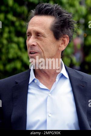 Producer Brian Grazer wears a black suit and white shirt while out and ...