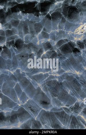 Abstract photo of the glow of the surface of transparent water. The ...
