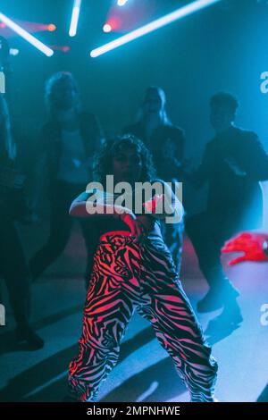 Carefree woman bending backwards against yellow background Stock Photo ...