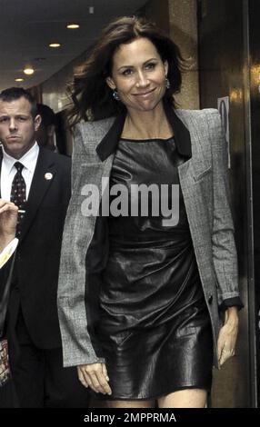 Minnie Driver, wearing a grey jacket over a black leather dress with lace-up heels, is all ...