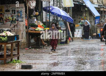A Palestinian walks in the rain in the Balata refugee camp, Nablus ...