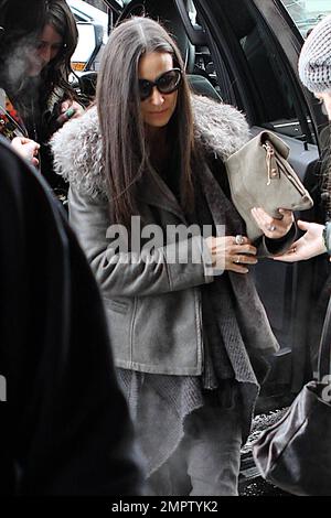 Demi Moore keeps warm in a grey jacket, jeans and lace-up boots while ...