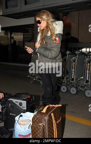A cheerful Denise Richards is seen arriving at LAX on a cool and cloudy ...
