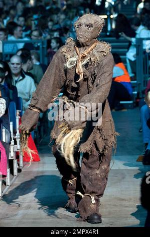A Scarecrow Monster walks down through the crowd at the "Doctor Who ...