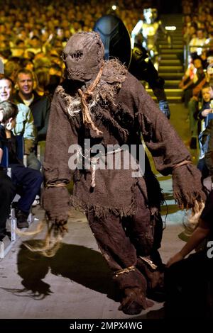 A Scarecrow Monster walks down through the crowd at the "Doctor Who ...