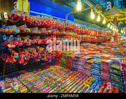 The stall of Night Market with hanging keychains and other souvenirs ...