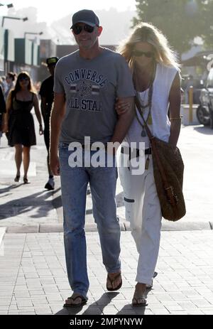 Elle Macpherson held on to her boyfriend Roger Jenkins' arm as they ...