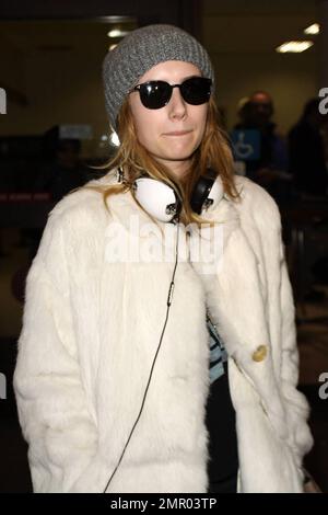 Actress Emma Roberts looks warm in a white fuzzy coat and grey hat as ...