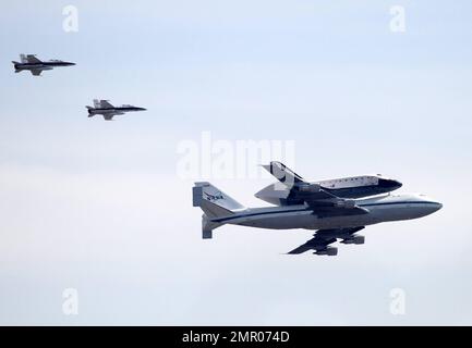 Accompanied by military jets, the Space Shuttle Endeavor finishes its ...