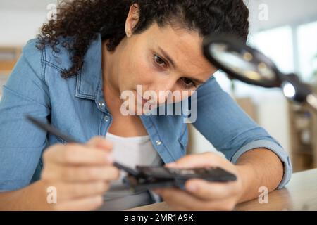 Young female PC technician posing seated at a desk in an office Stock ...