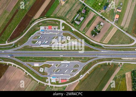 Diminishing aerial perspective of rest area on highway, top down ...