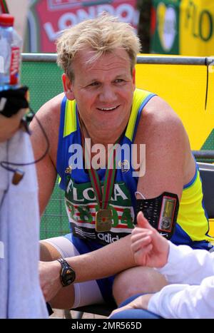 Gordon Ramsay shows off his medal after completing the Flora London ...