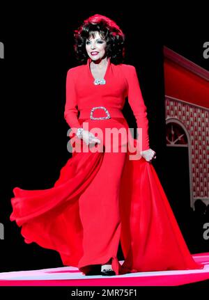 Joan Collins models a red dress at the annual Heart Truth Fashion Show ...