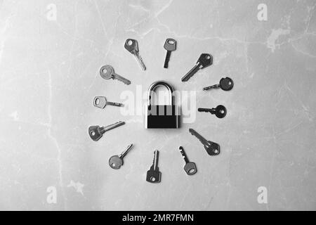 Steel padlock and keys on marble background, flat lay. Safety concept ...