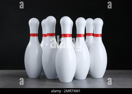 Set of bowling pins on grey stone table Stock Photo - Alamy