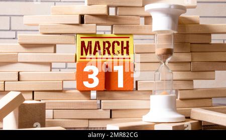 March 31st. Image of march 31 wooden color calendar on white brick wall ...