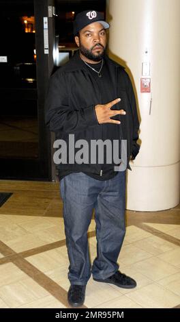 EXCLUSIVE!! Rapper Ice Cube flashes a peace sign as he poses for photos ...