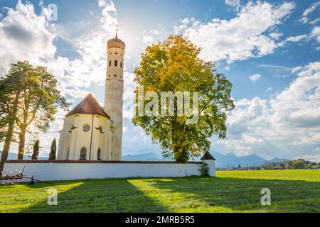 St. Coleman's Church in idyllic Bavarian alps meadows, Germany, border ...