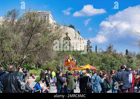 A crowd of tourists around the Acropolis of Athens Unesco heritage with ...