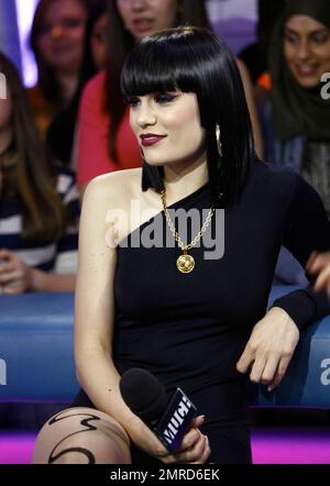 Wearing a black unitard with one black leg and a white one with a black ...