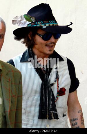 "Dark Shadows" star Johnny Depp wears a feathered hat as he signs ...