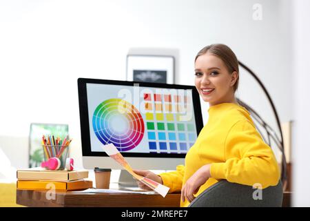 Female graphic designer with color palettes in office Stock Photo - Alamy