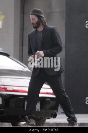 Exclusive!! A sad looking Keanu Reeves tenderly opens the car door for ...