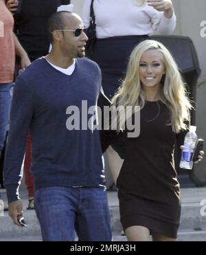 Kendra Wilkinson and Hank Baskett look very much the happy couple as ...