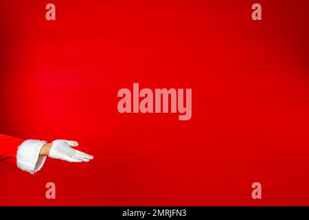 A view of the Santa Clause's hand on a red background Stock Photo - Alamy