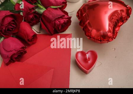 Envelopes, gift, candle and rose on light background. Valentine's Day ...