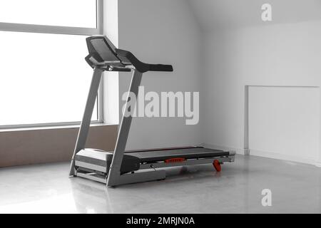 Interior of room with modern treadmill near pink wall Stock Photo - Alamy