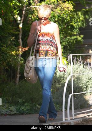 Kim Stewart sports a hippy top and short hair do during a visit to a ...