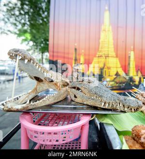 A Crocodile meat,street seller shows off two dried croc heads,mouths ...