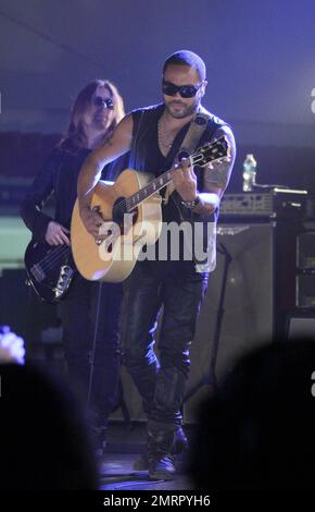 Lenny Kravitz shows off his tattoos in a sleeveless leather vest as he ...