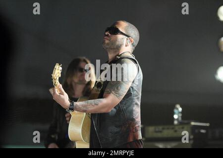 Lenny Kravitz shows off his tattoos in a sleeveless leather vest as he ...