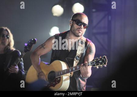 Lenny Kravitz shows off his tattoos in a sleeveless leather vest as he ...