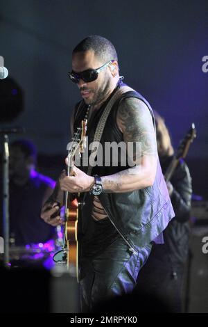 Lenny Kravitz shows off his tattoos in a sleeveless leather vest as he ...
