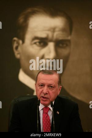 Backdropped by a poster of Mustafa Kemal Ataturk, left, the founder of ...