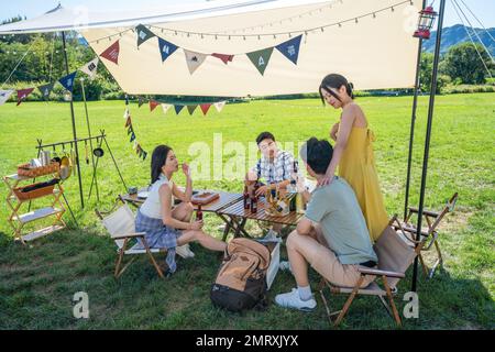 A group of people sat under the awning Stock Photo - Alamy